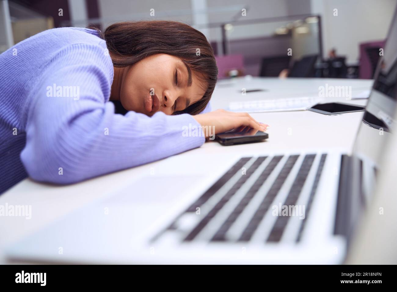 Brunette woman employee falling asleep at her workplace Stock Photo - Alamy