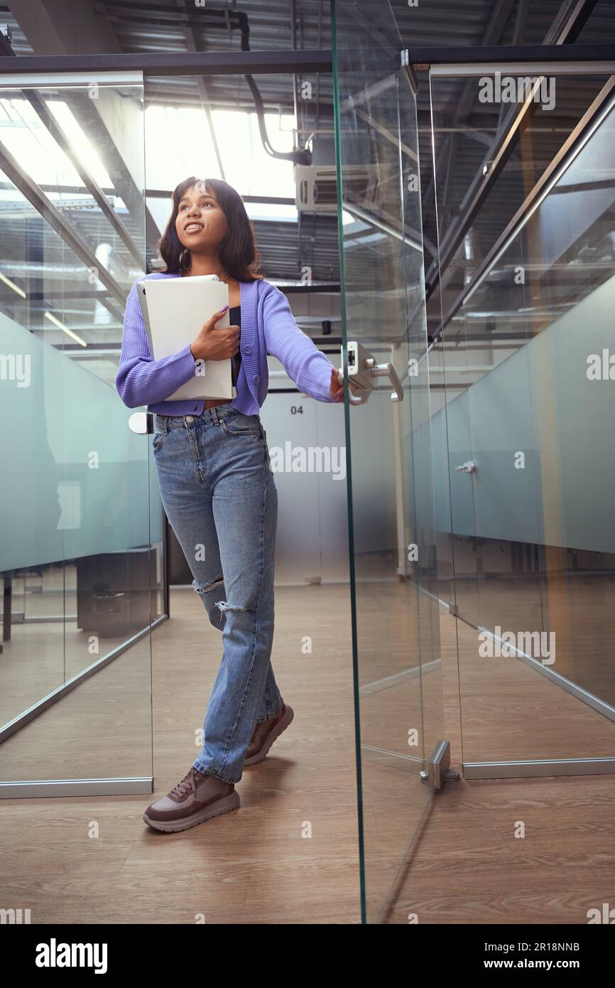 Mid adult woman entering room hi-res stock photography and images - Alamy