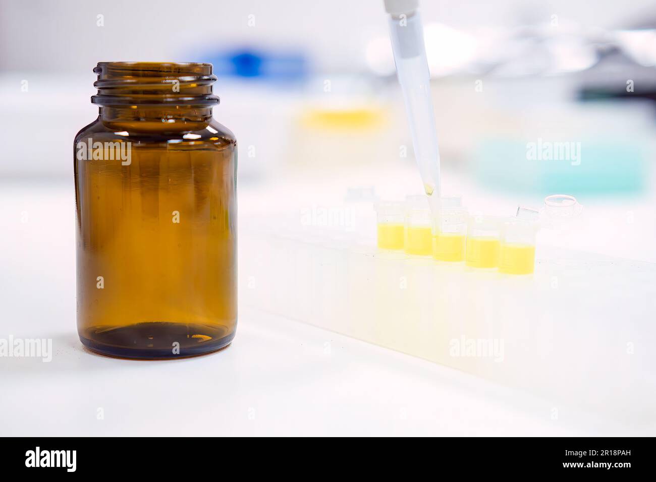 Chemical laboratory. Filling stock reagents with an automatic pipette ...