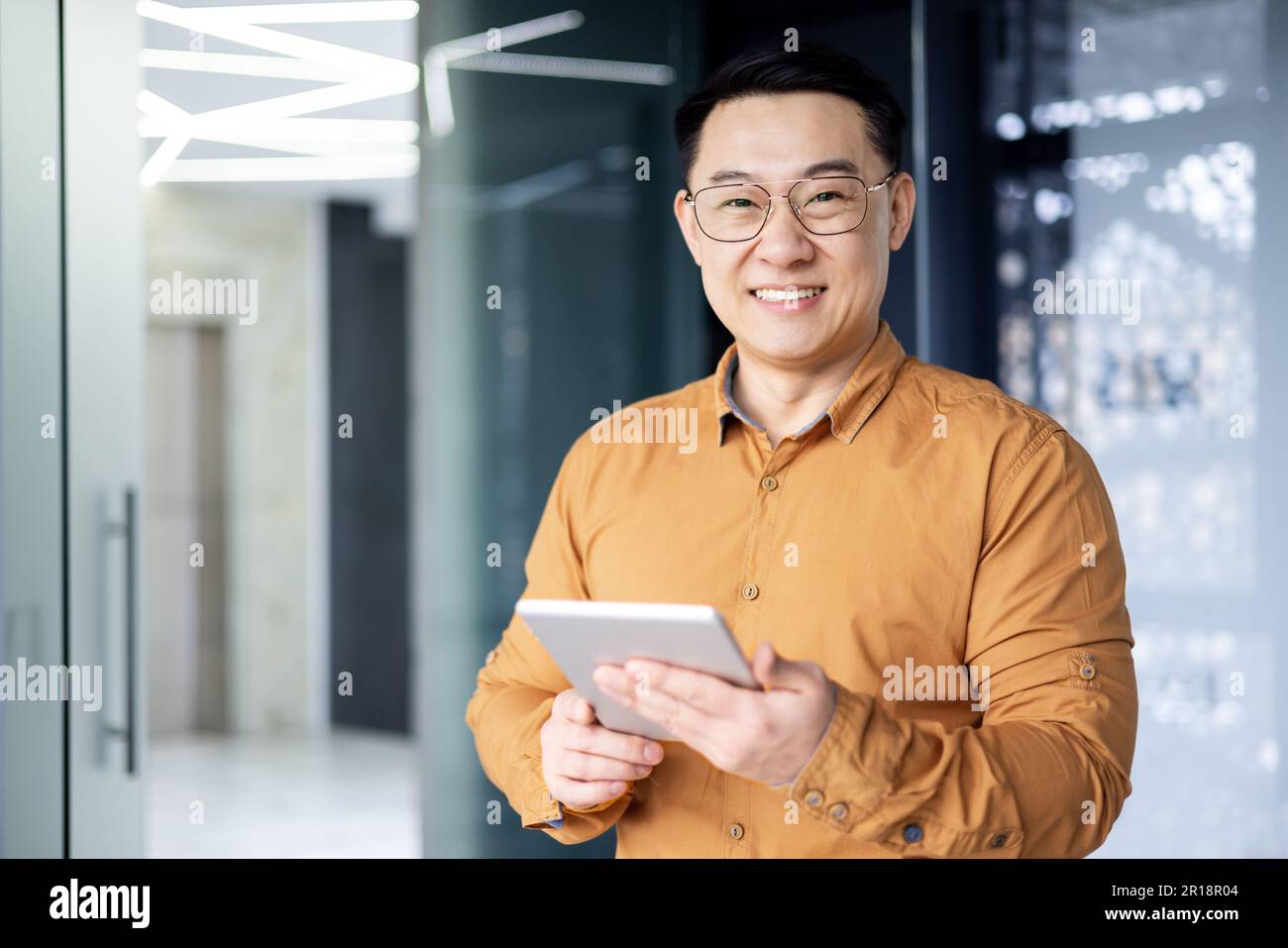 Portrait of young programmer with tablet computer inside office,asian ...