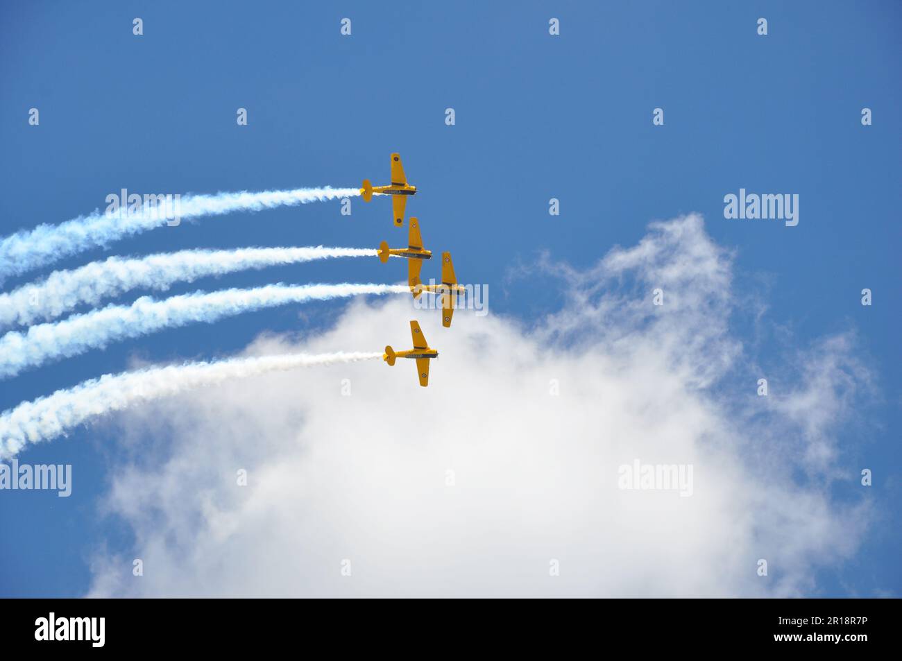 Four yellow planes at airshow with smoke in cloudy sky Stock Photo - Alamy