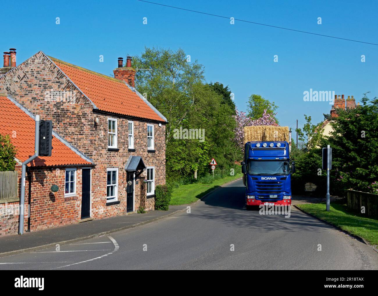 Lorry loaded with hay bales in the village of Welwick, East yorkshire ...