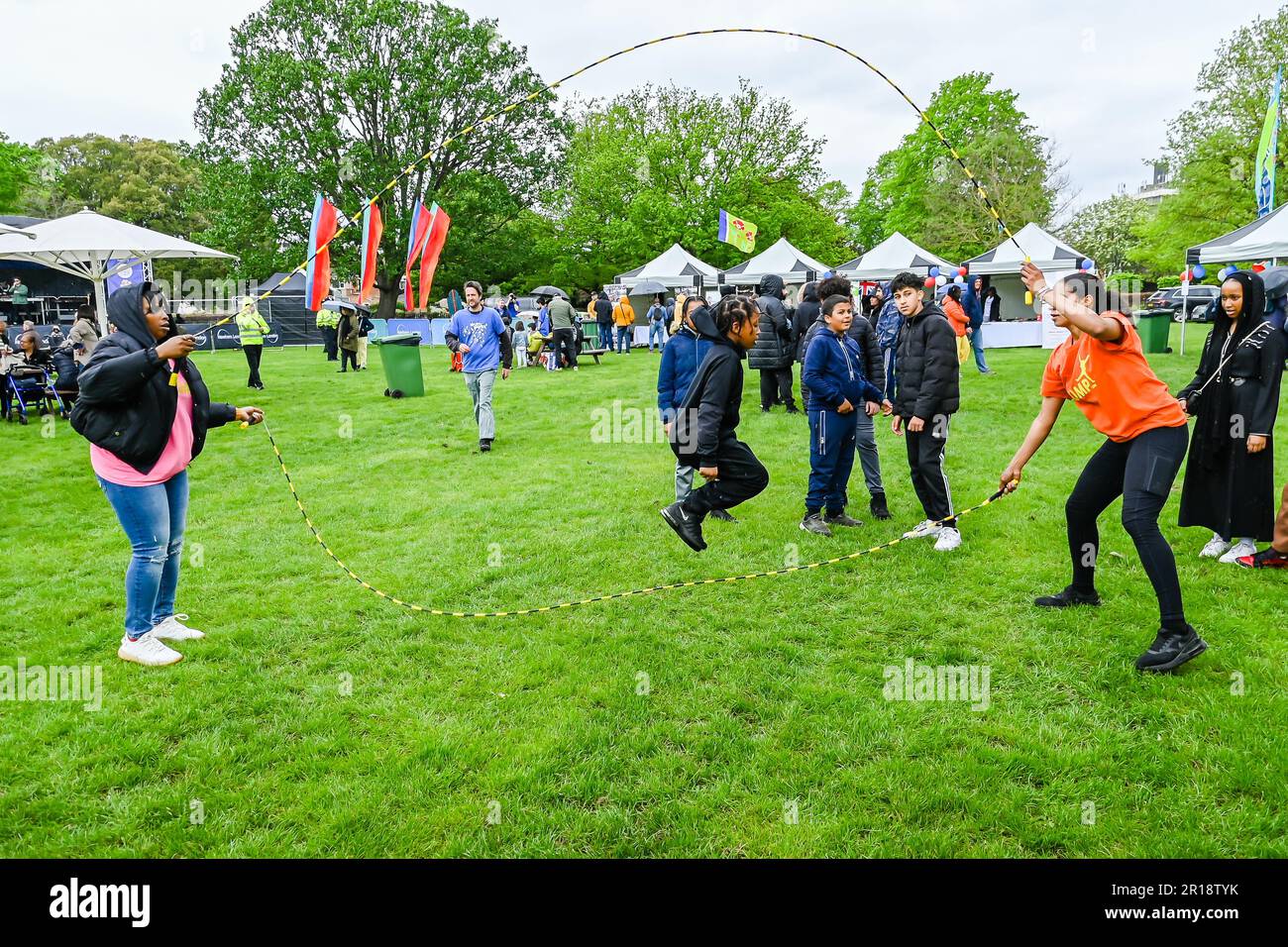 young people jumping ropes in park Stock Photo - Alamy