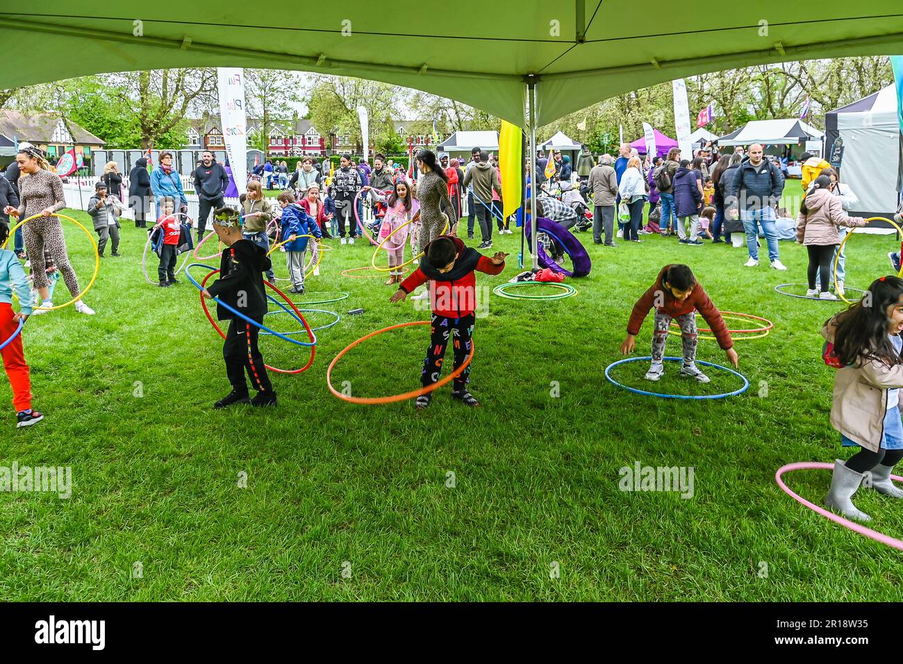 Children playing with hula hoop in festival Stock Photo - Alamy