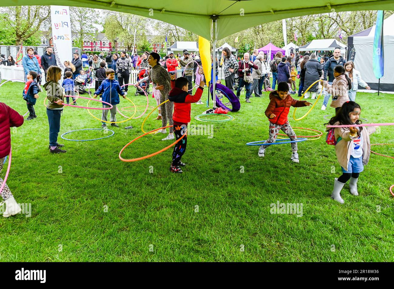 Children playing with hula hoop in festival Stock Photo - Alamy