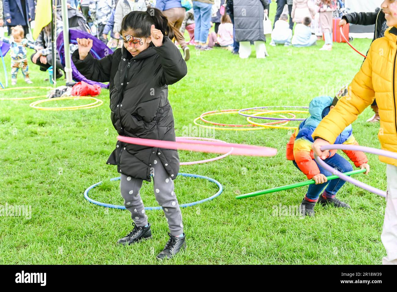 Children playing with hula hoop in festival Stock Photo - Alamy