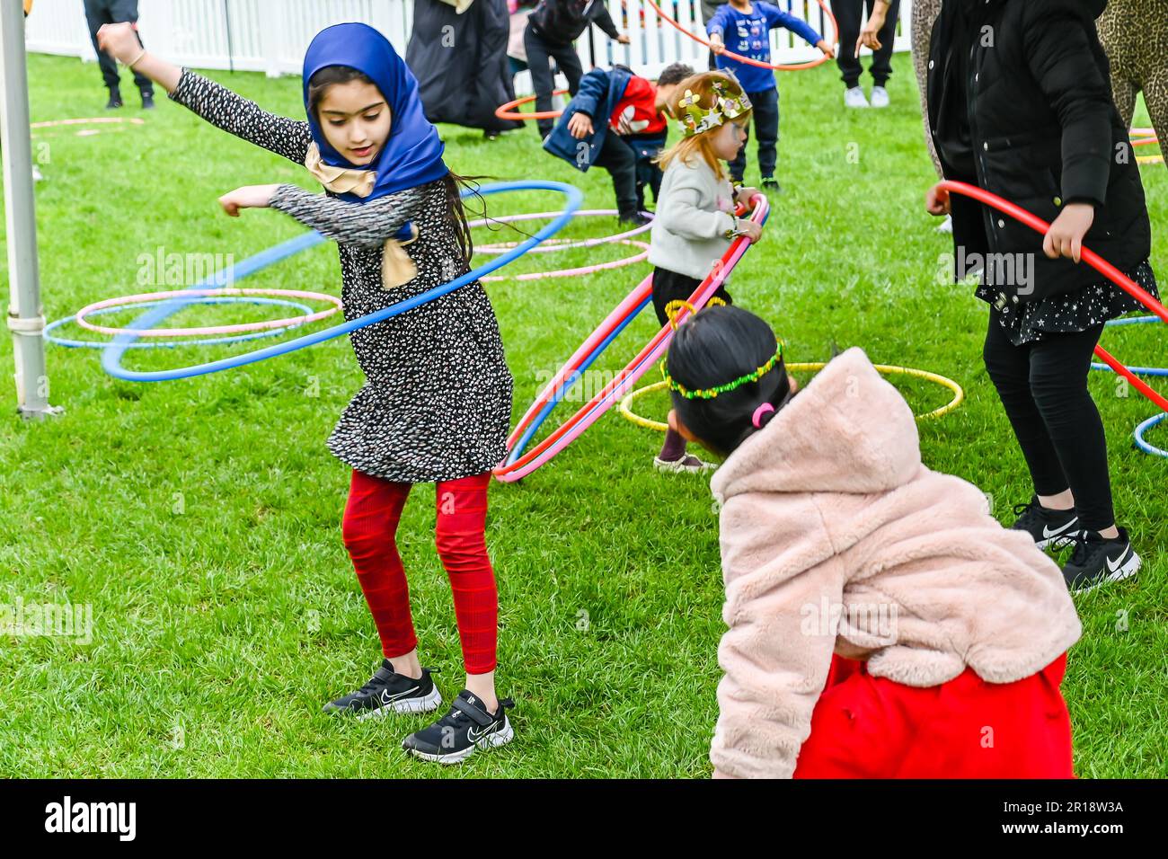 Children playing with hula hoop in festival Stock Photo - Alamy