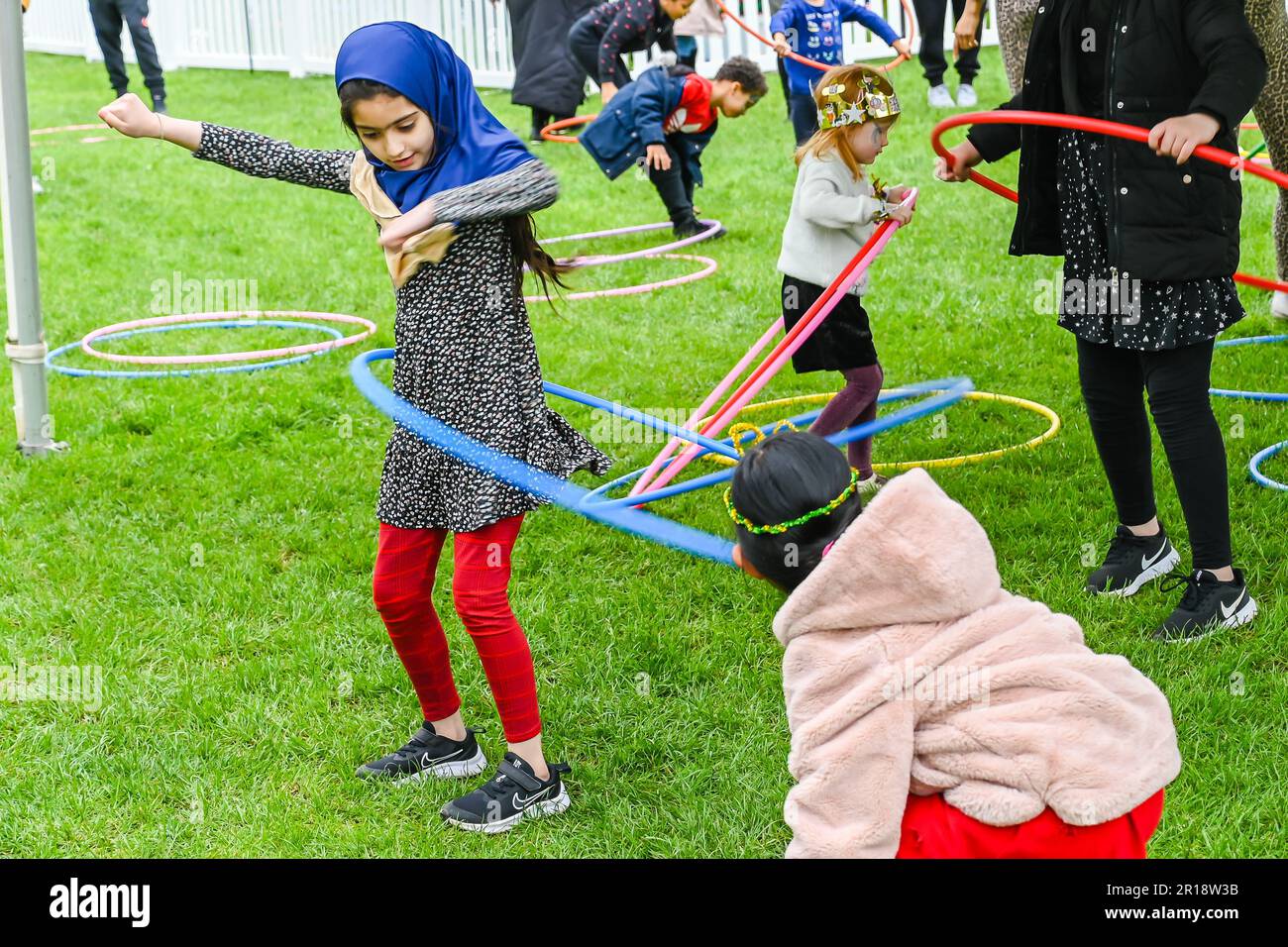 Children playing with hula hoop in festival Stock Photo - Alamy
