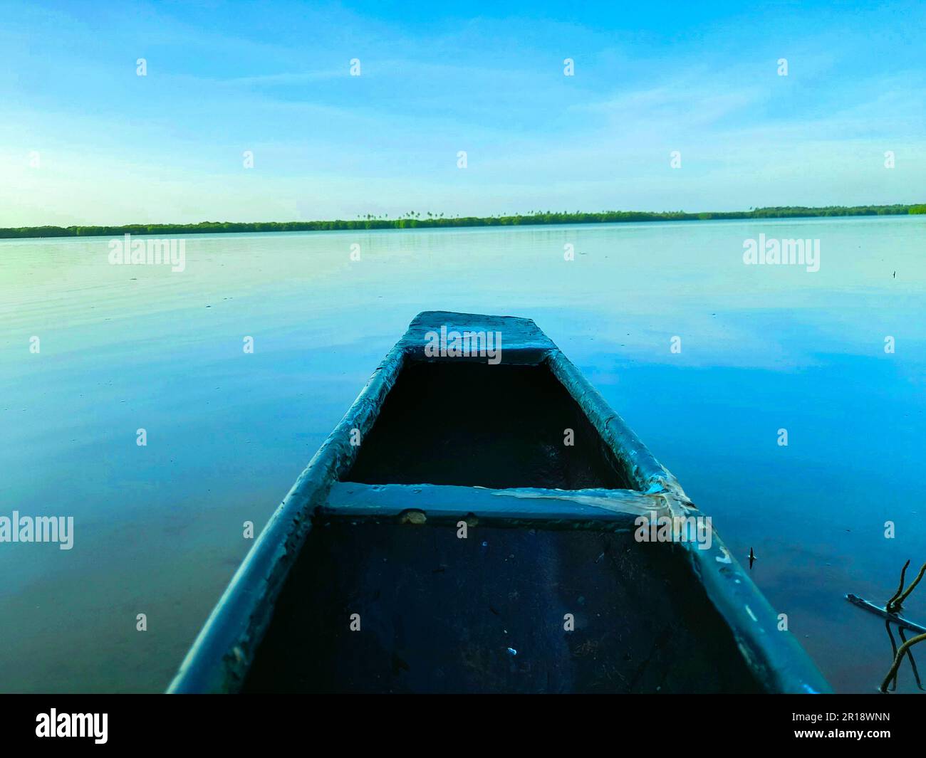 Canoeing view at the front of the canoe. Blue background landscape ...