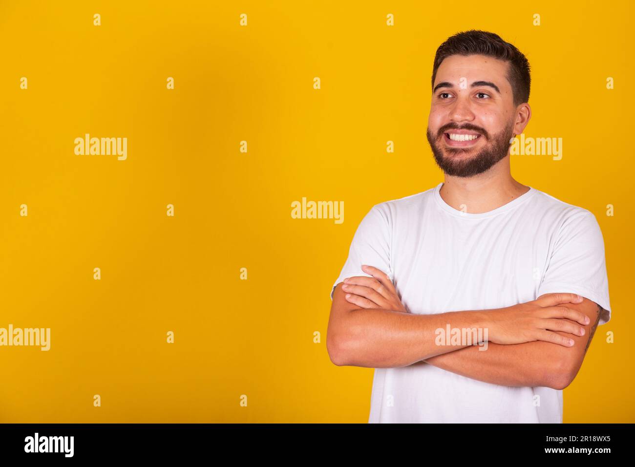 Latin American man with arms crossed, smiling, empowered, confident ...