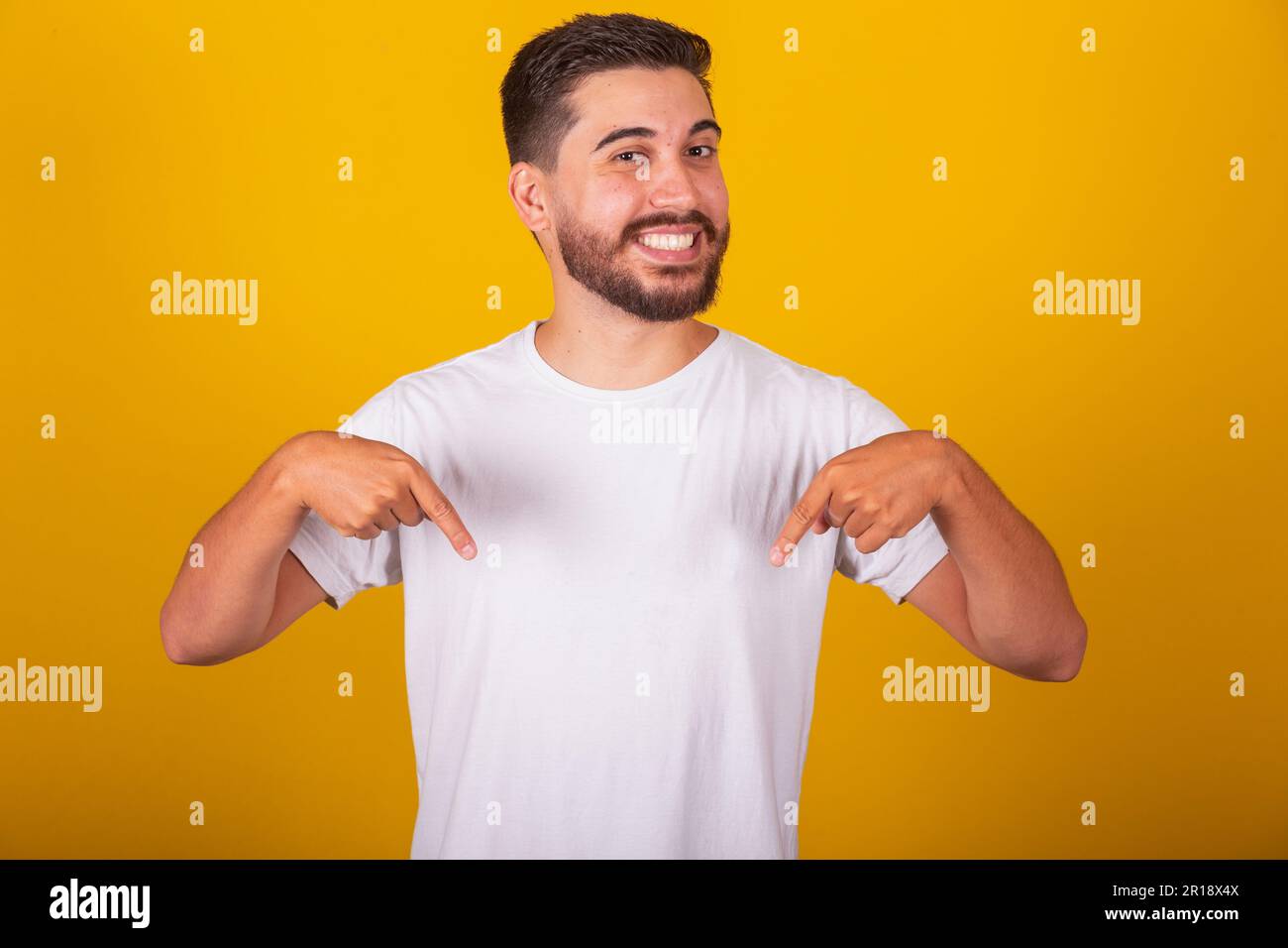 Brazilian Latin American man, with fingers pointing here, pointing to ...