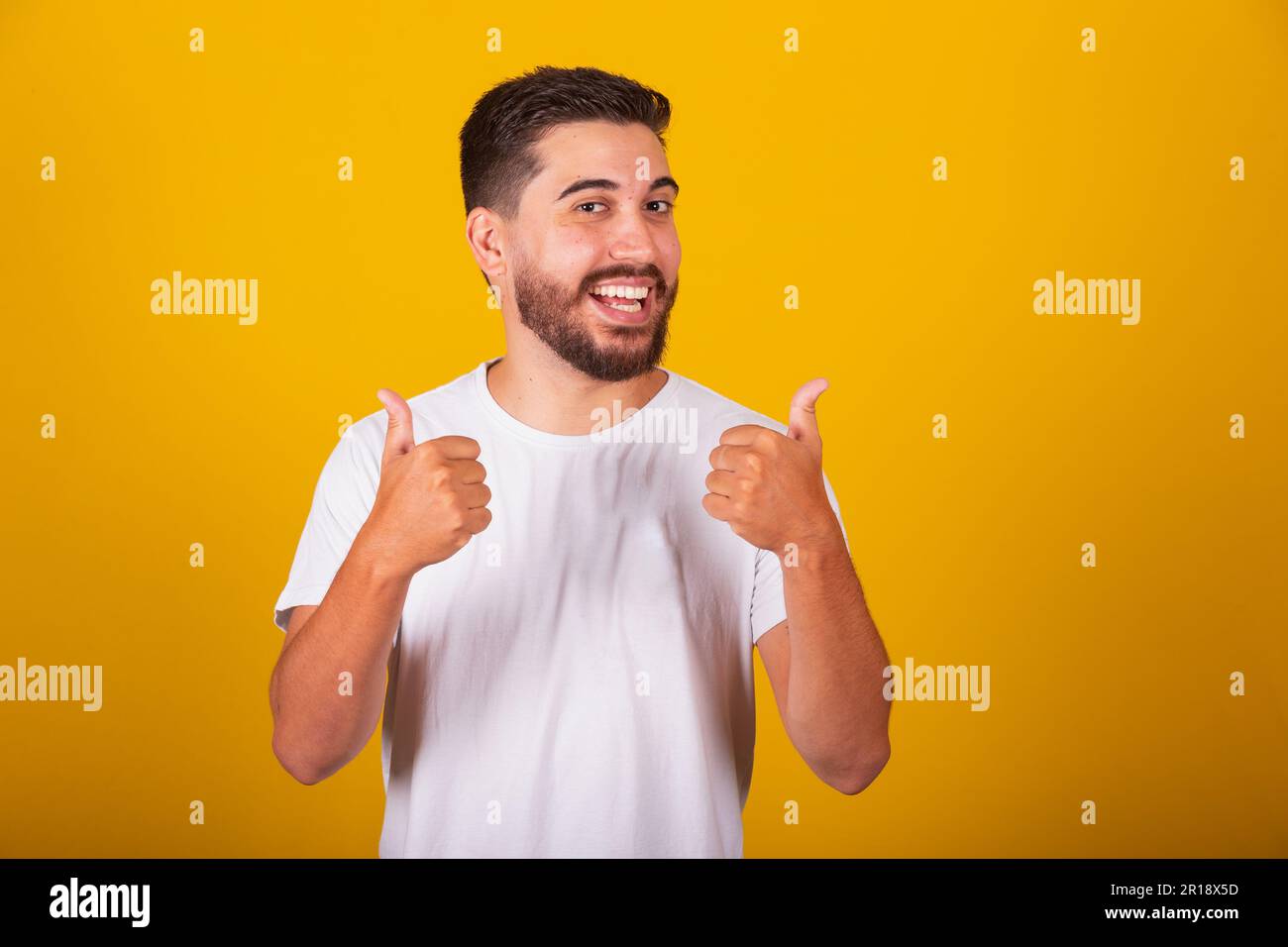 Brazilian Latin American man with thumb up, symbol of positive ...