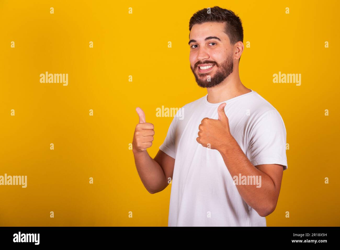 Brazilian Latin American man with thumb up, symbol of positive ...