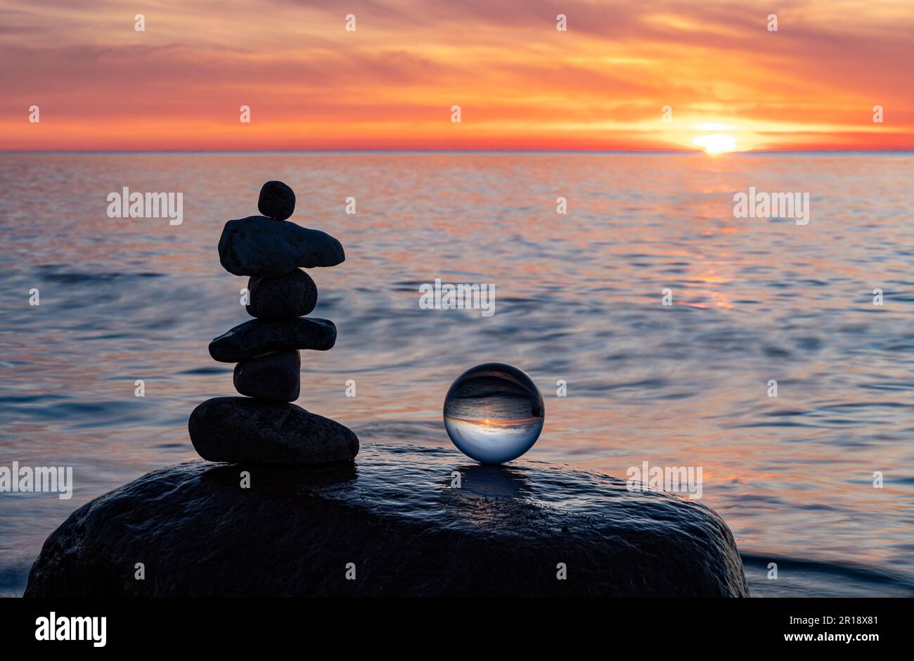 Stone pyramids and glass sphere on the dreamy Baltic Sea sand beach on ...