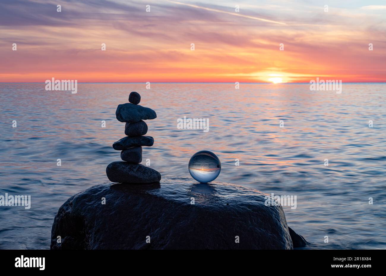 Stone pyramids and glass sphere on the dreamy Baltic Sea sand beach on ...