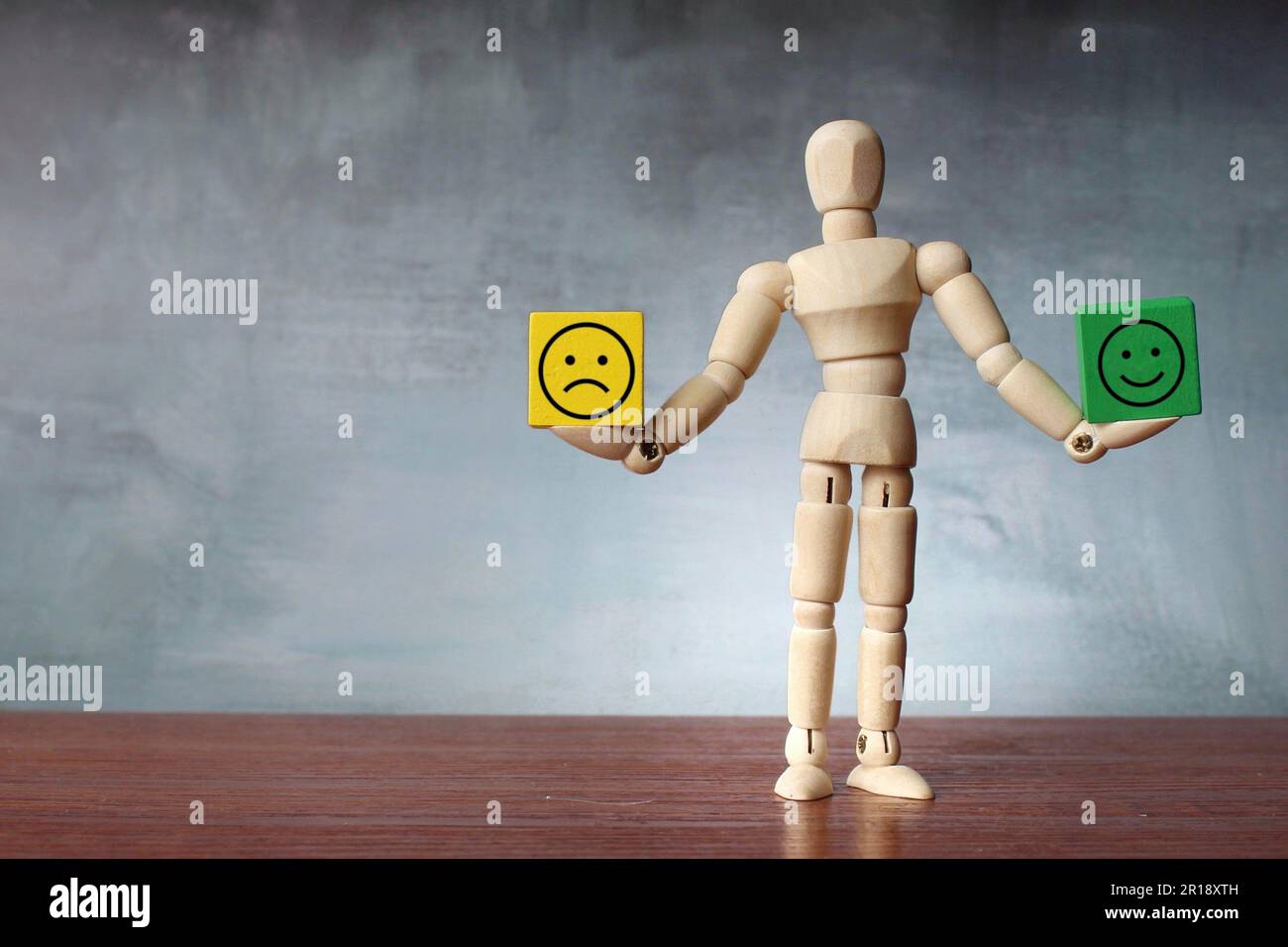 Wooden doll hold cubes with happy and sad face. Feedback rating ...