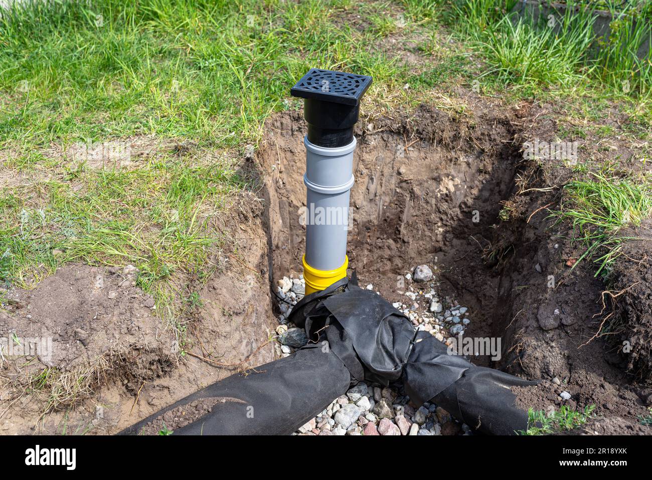 Overflow and infiltration well connected to drainage pipes, buried in a ...