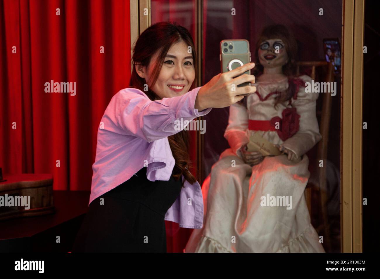 Visitors took a selfie with a horor movie character, Annabelle puppet ...