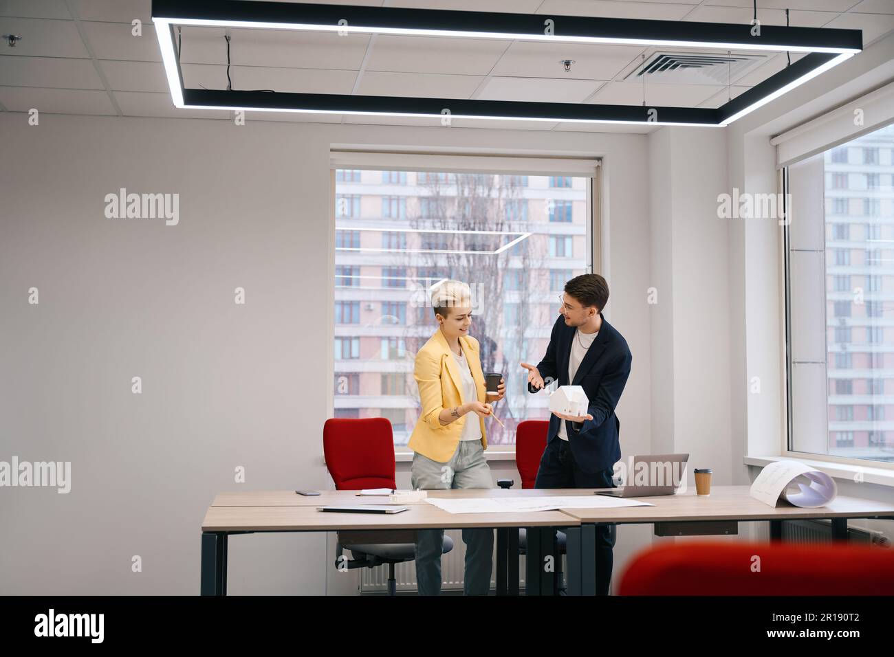 Designers are developing paper layout oh house Stock Photo - Alamy