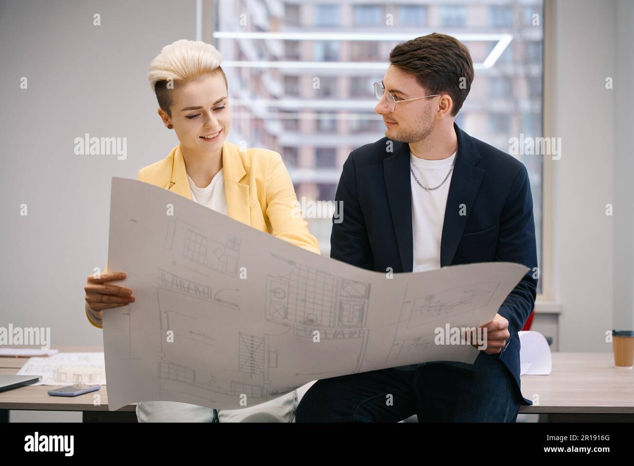 Independent constructors viewing blueprint in the office Stock Photo ...