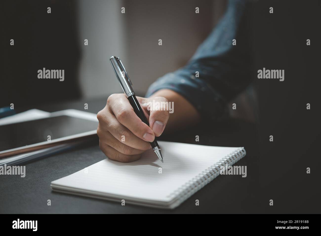 learning online class by using laptop computer and writing notebook at ...