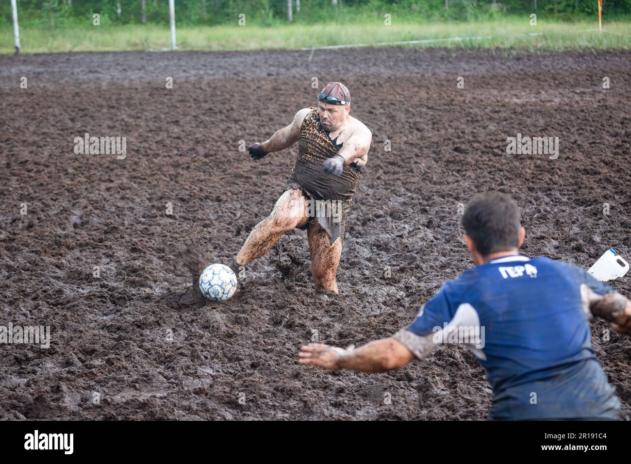 SWAMP SOCCER, FINLAND, 2014: A goalkeeper in action trying to prevent a ...