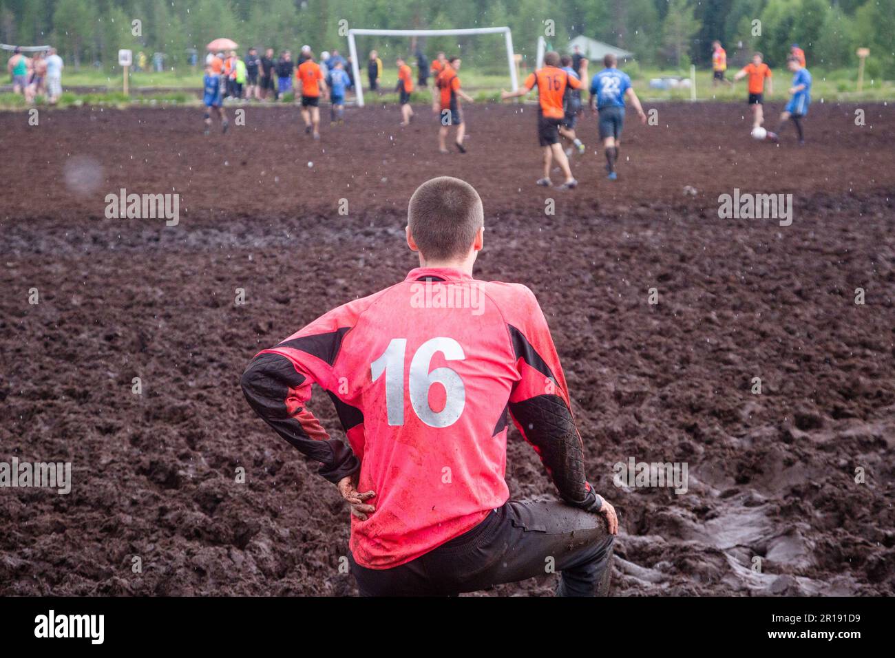 SWAMP SOCCER, FINLAND, 2014: A goalkeeper in action trying to prevent a ...