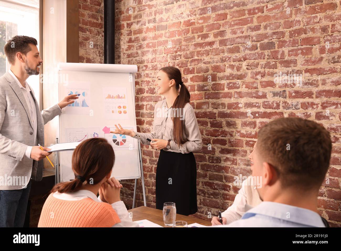 Employees having meeting in office. Team work Stock Photo - Alamy