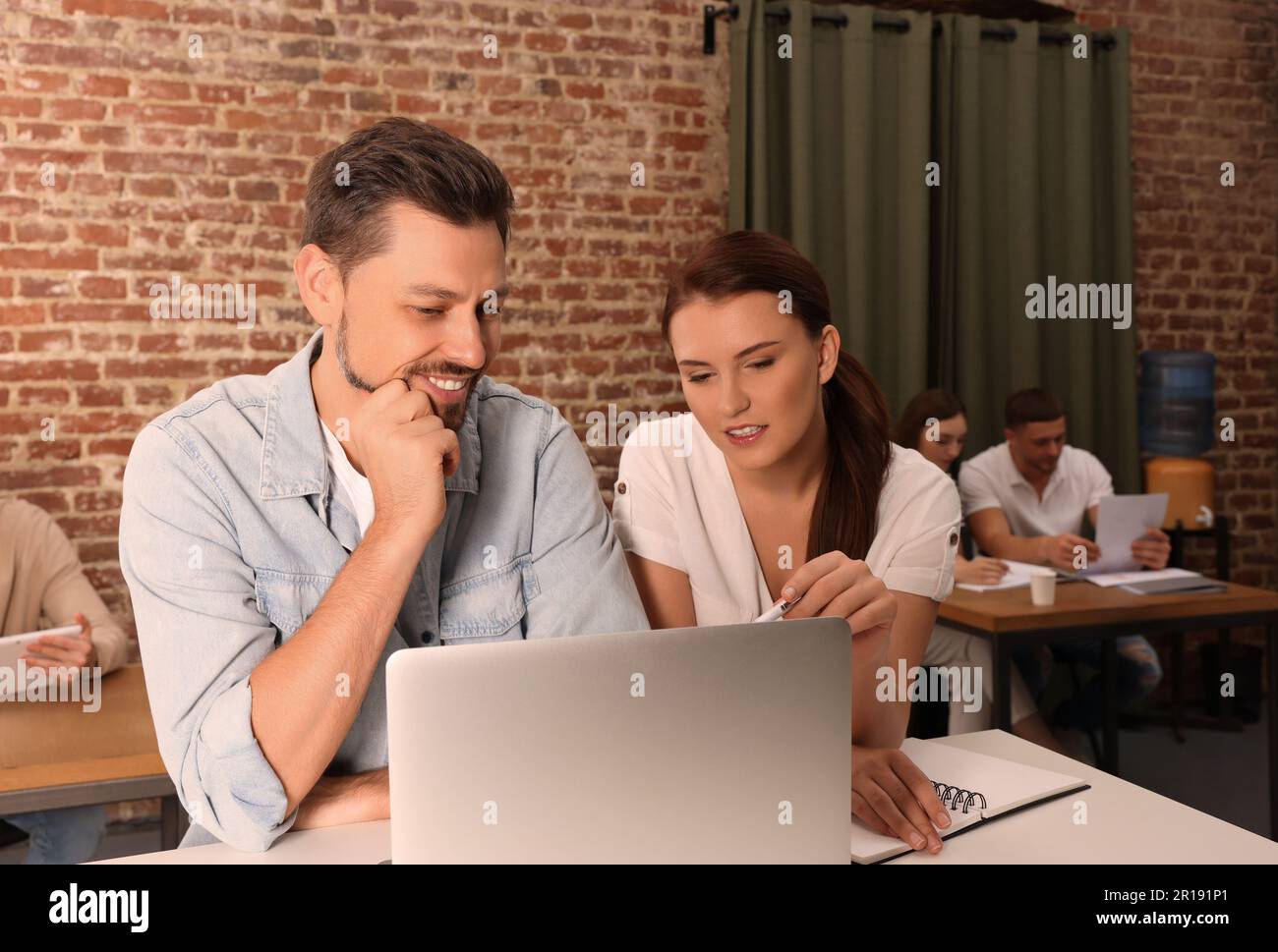 Team of employees working together in office Stock Photo - Alamy