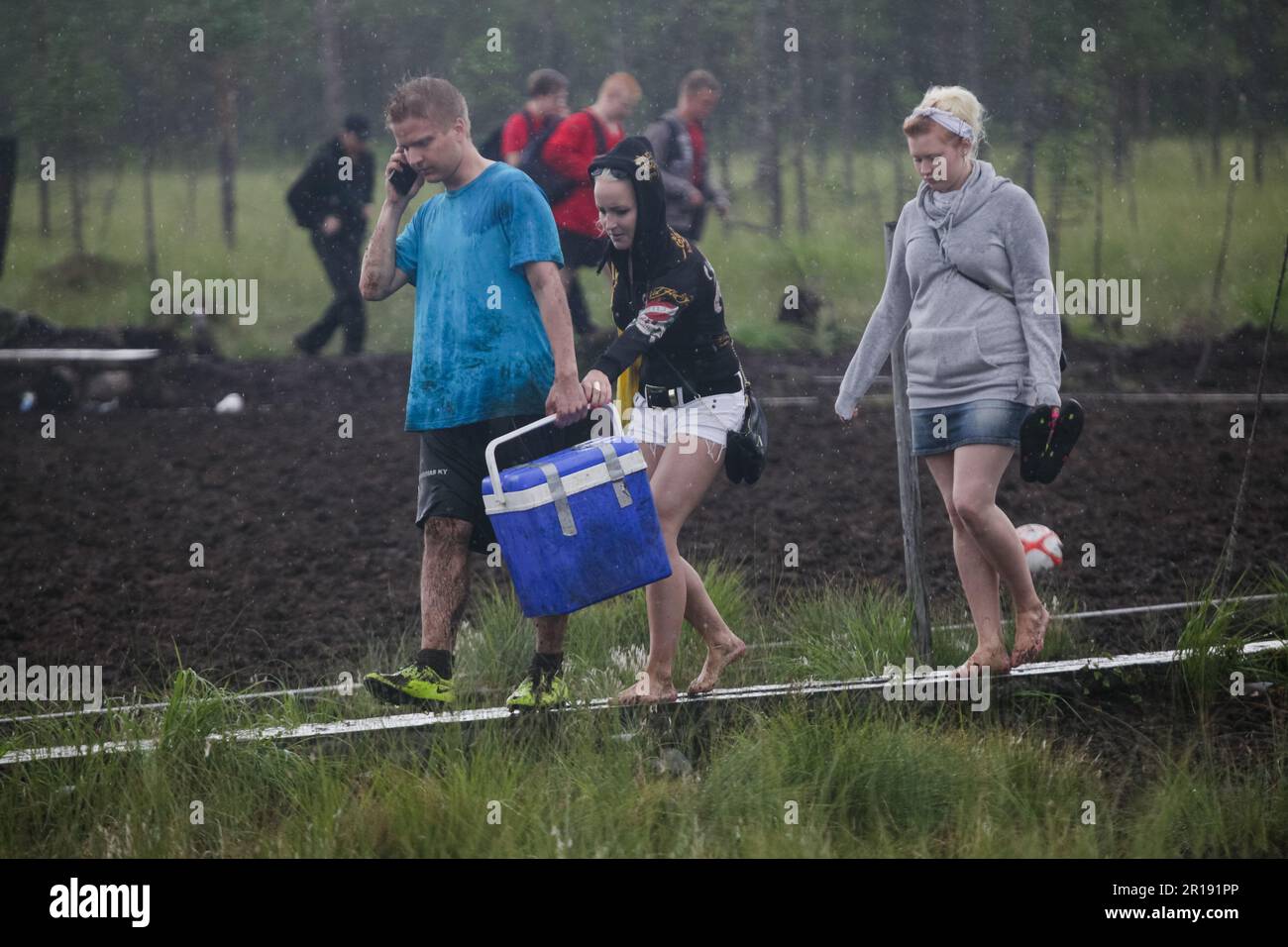 SWAMP SOCCER, FINLAND, 2014: Players and fans navigate the wooden ...