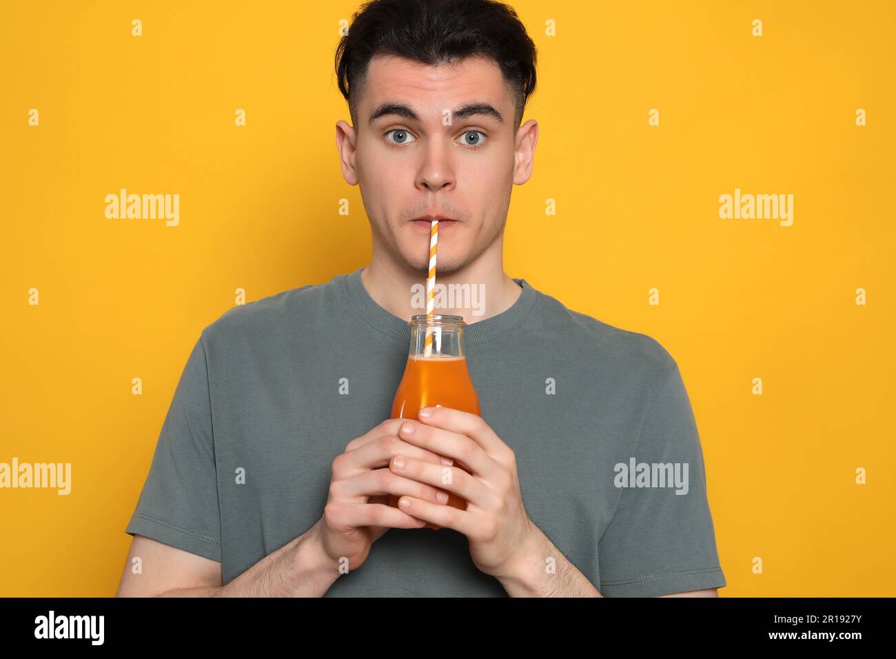 Man straw orange juice hi-res stock photography and images - Alamy