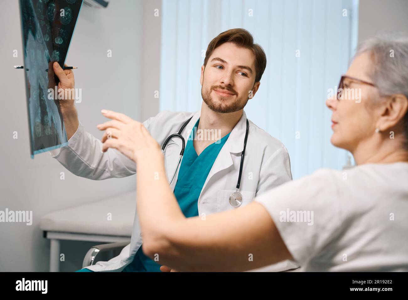 Practitioner showing brain mri scan to old lady Stock Photo - Alamy