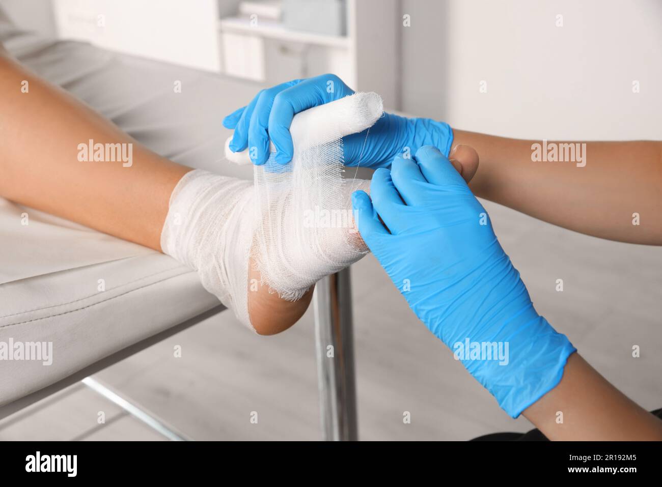 Doctor applying bandage onto patient's foot in hospital, closeup Stock ...