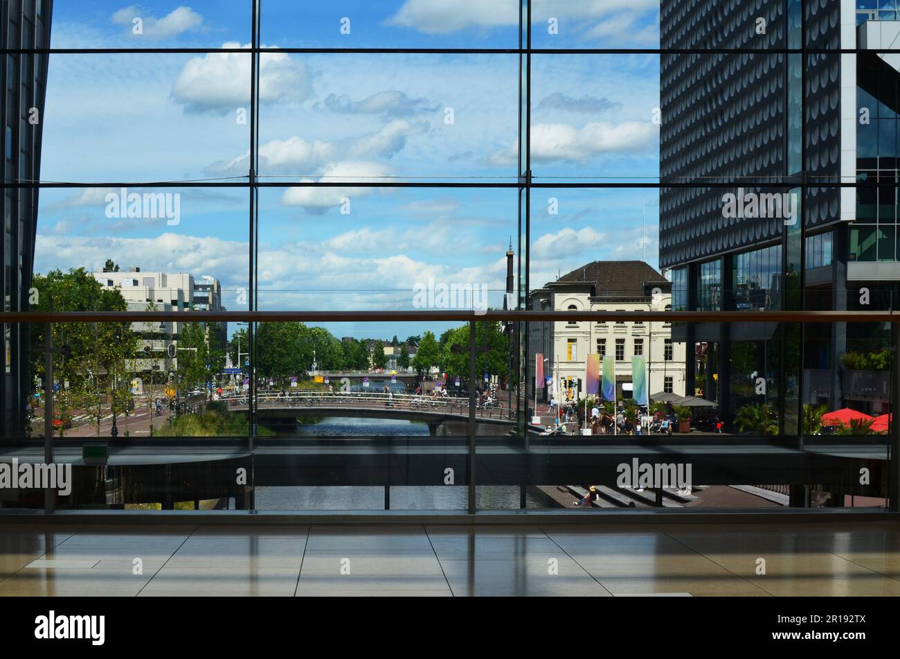 Beautiful city street with buildings, view through big glass windows ...