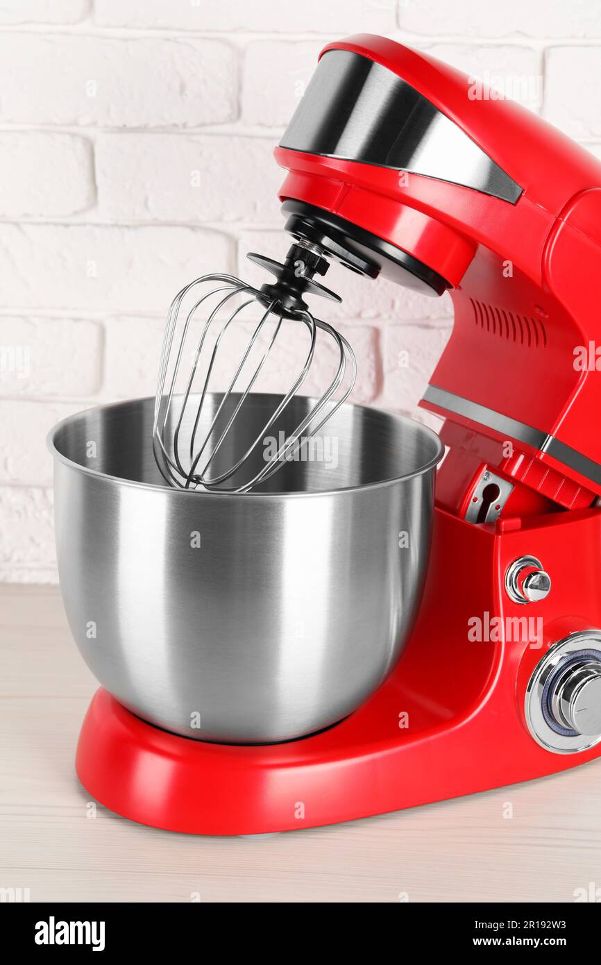 Modern red stand mixer on white wooden table Stock Photo - Alamy