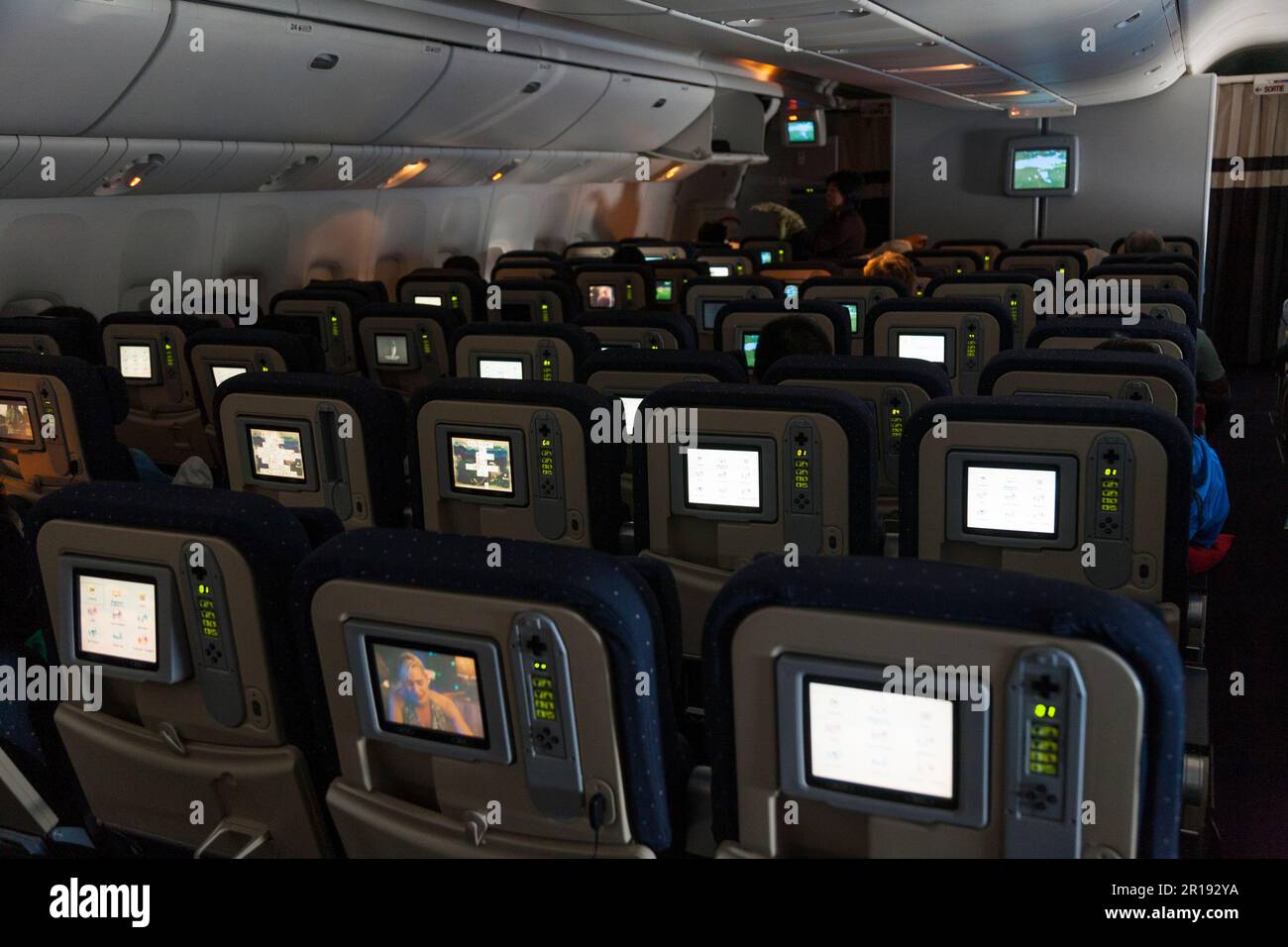 Darkened interior cabin of a wide bodied jet plane / airplane ...