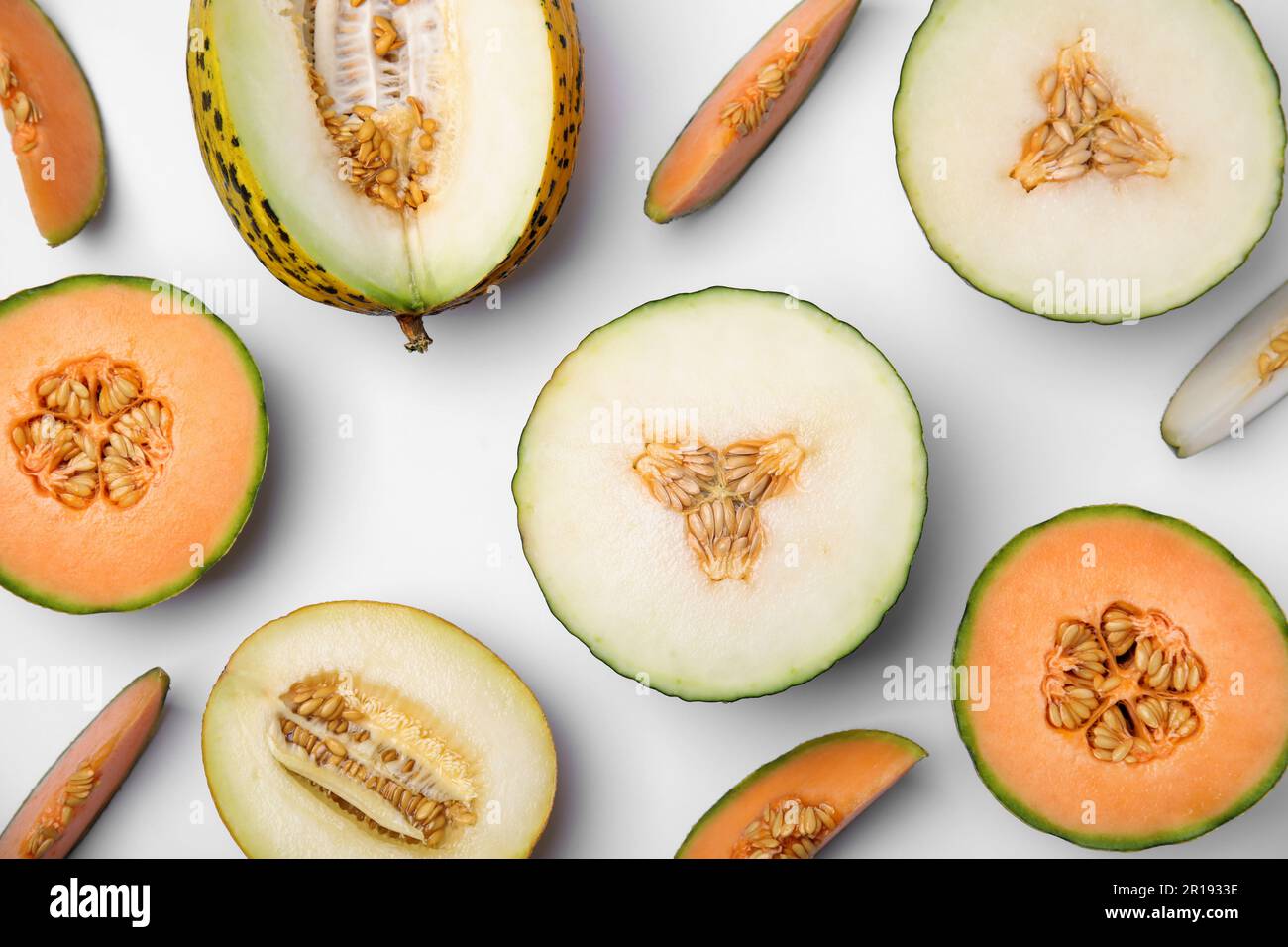 Cut different types of melons on white background, flat lay Stock Photo ...