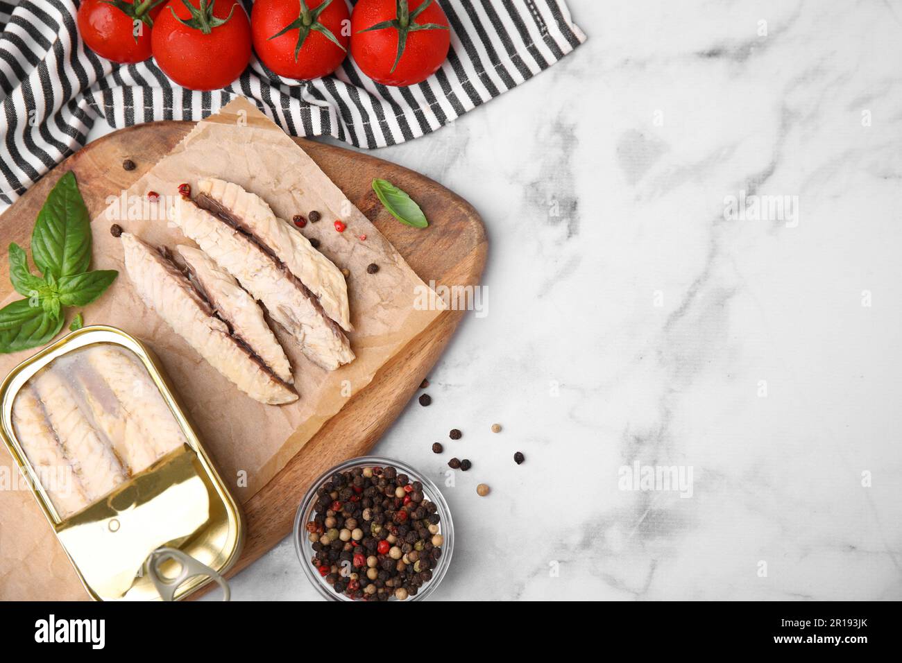Canned mackerel fillets served on white marble table, flat lay. Space ...
