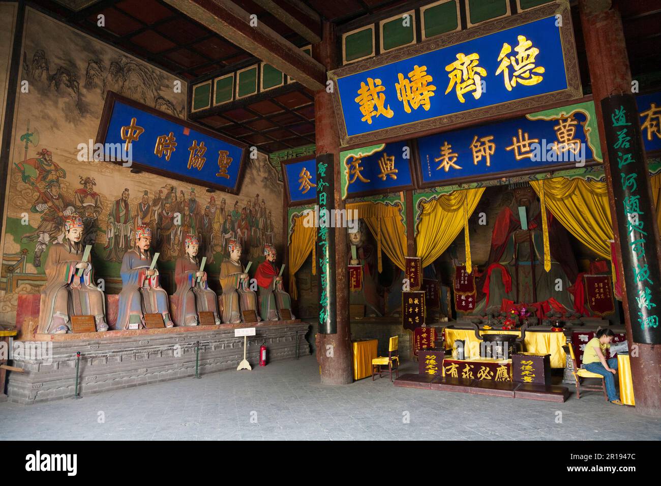 Interior inside the Dacheng Hall (main hall and first building) with large statues of deities ...