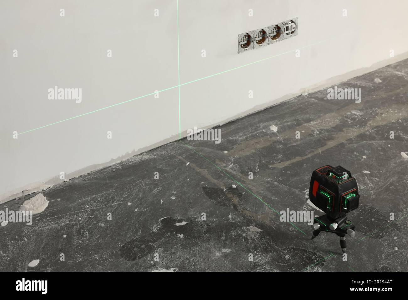 Laser level on floor near electrical sockets Stock Photo - Alamy