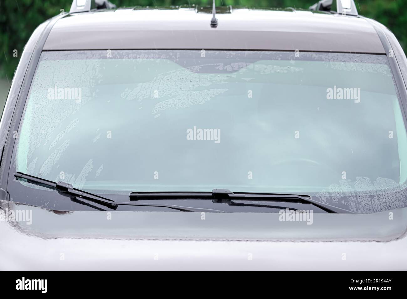 Car wipers cleaning water drops from windshield glass, closeup Stock ...