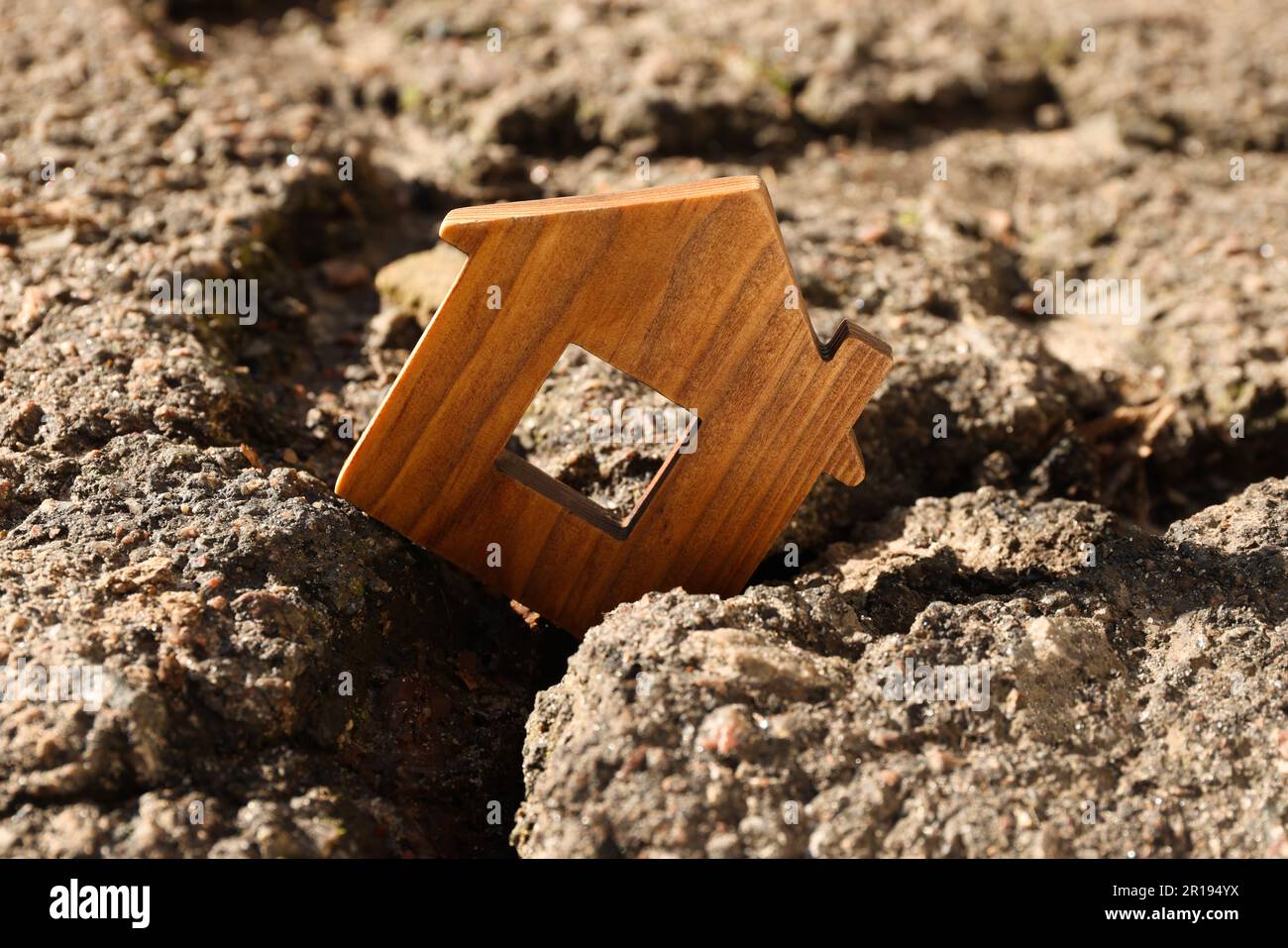 Wooden house model in cracked asphalt. Earthquake disaster Stock Photo ...