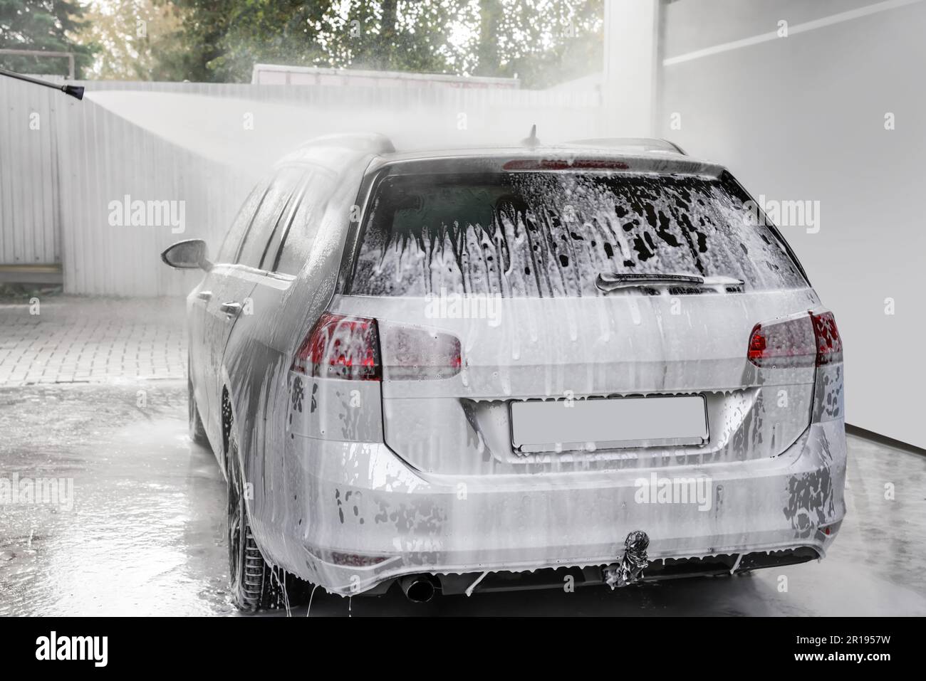 Washing auto with high pressure water jet at outdoor car wash Stock ...