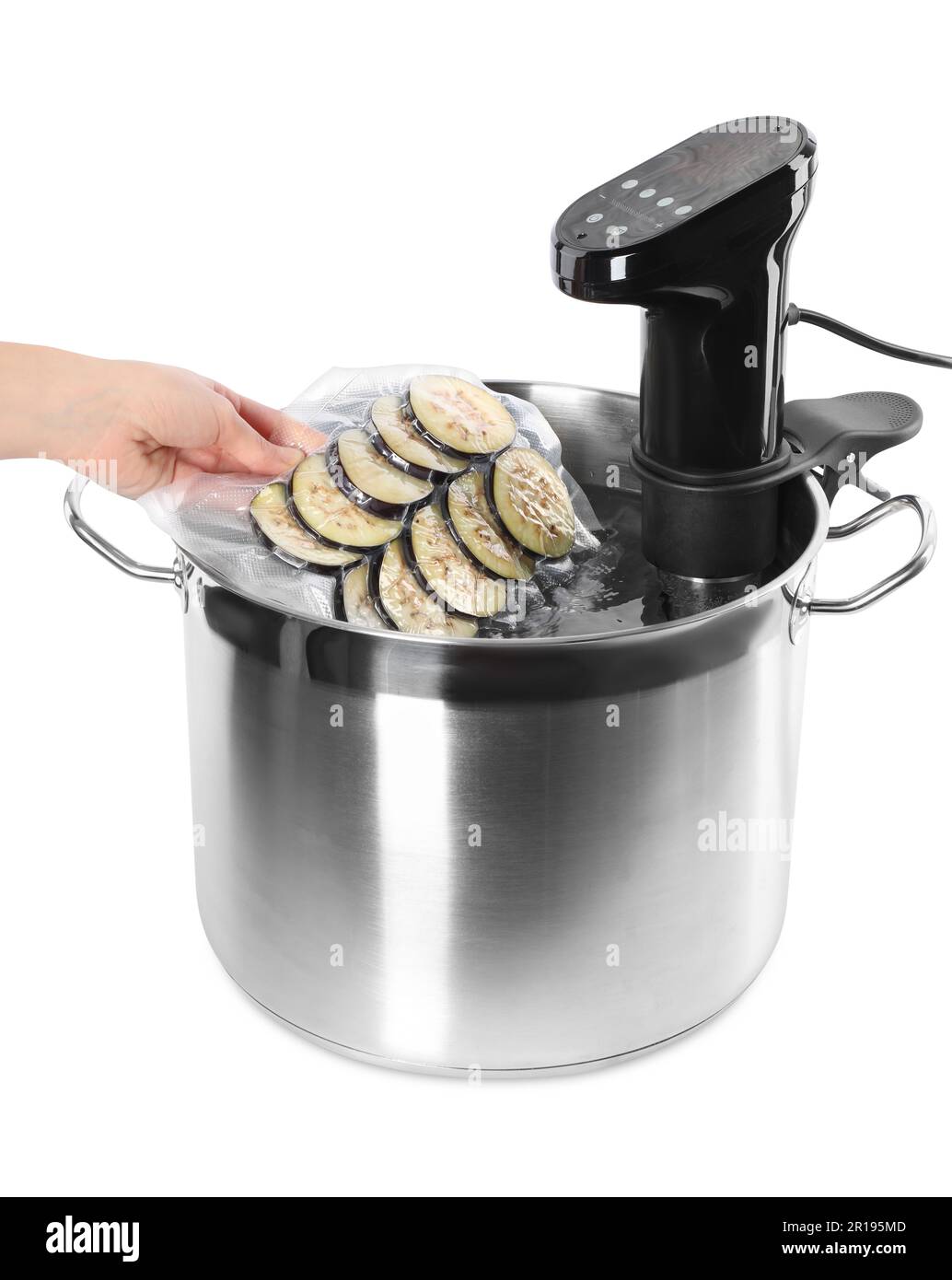 Woman putting vacuum packed eggplant into pot with sous vide cooker on ...