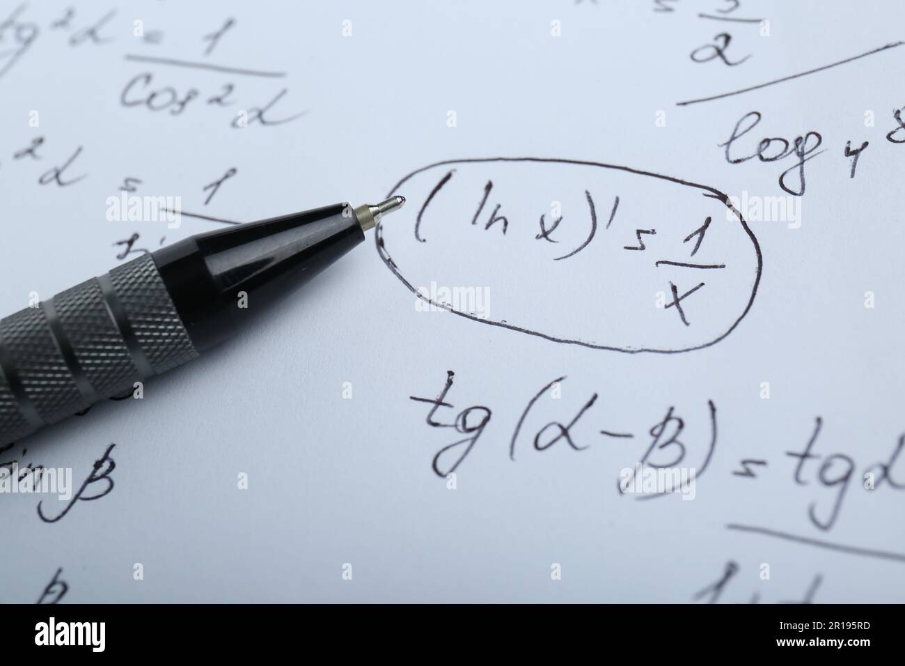 Sheet of paper with different mathematical formulas and pen, closeup ...