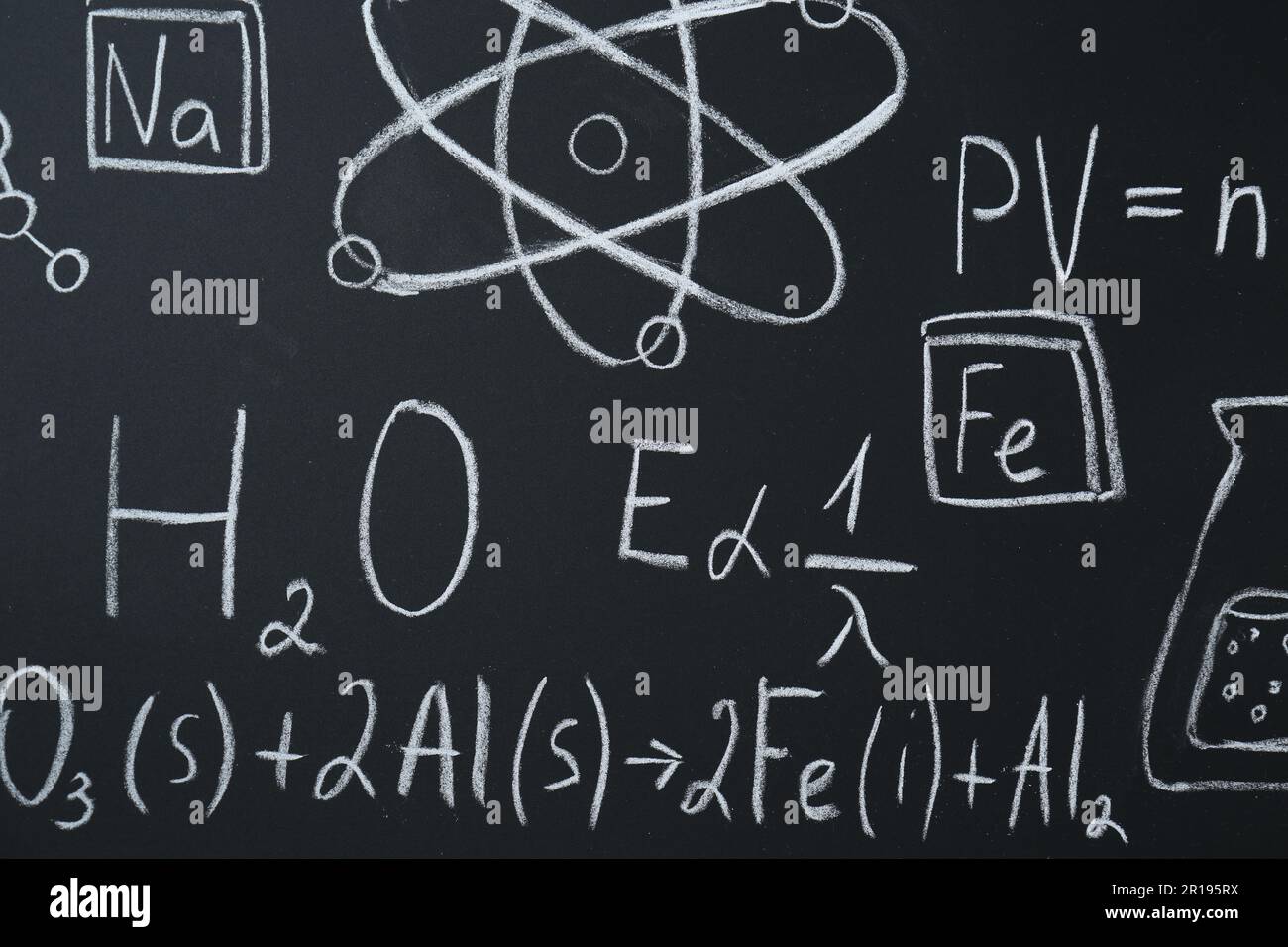 Different chemical formulas written with chalk on blackboard, closeup ...