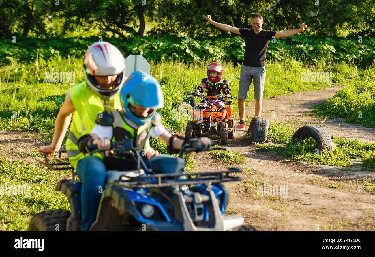 A child rides a quad bike through the mud. ATV rider rides Stock Photo ...