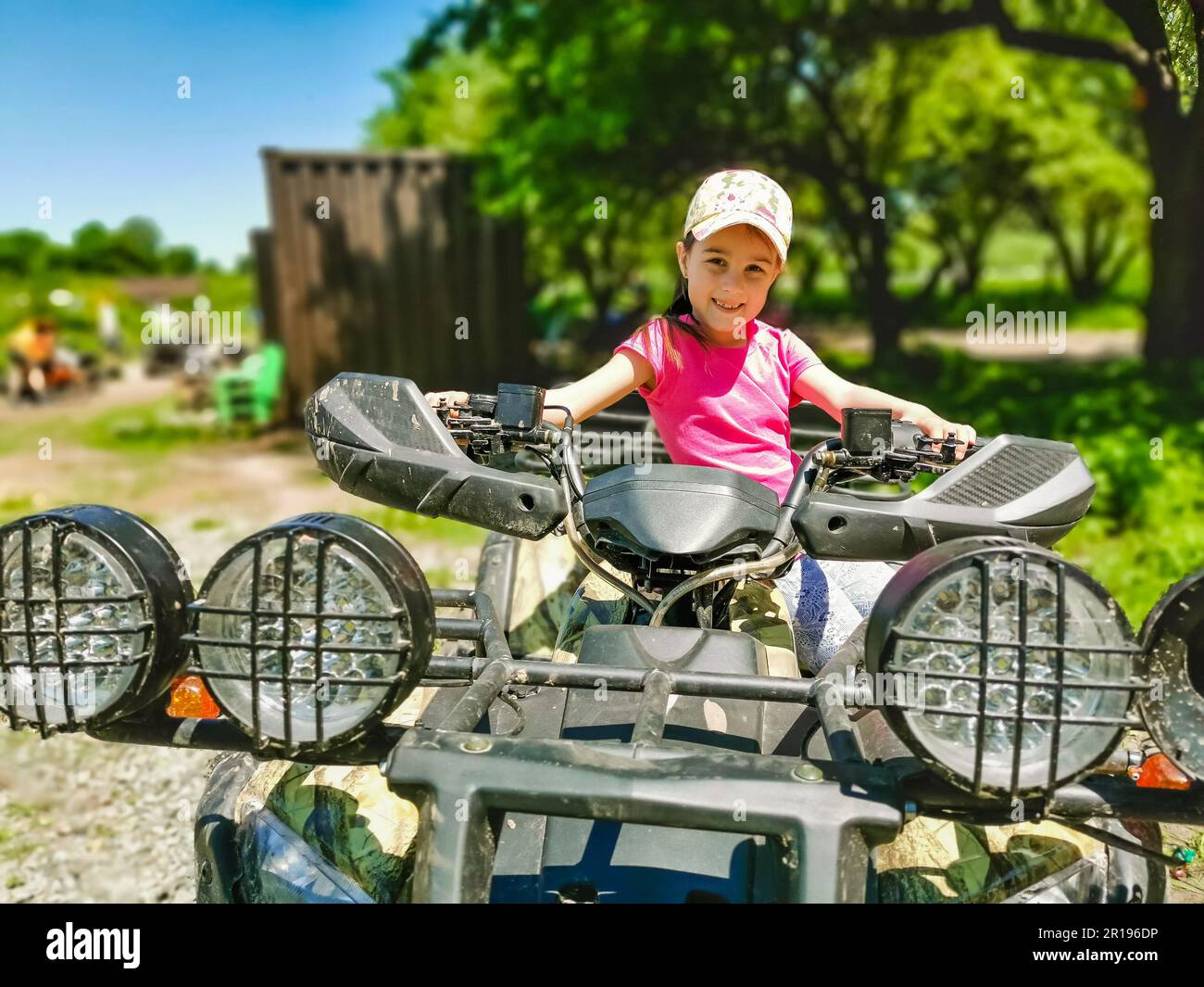 Girl riding an electric quad bike Stock Photo - Alamy