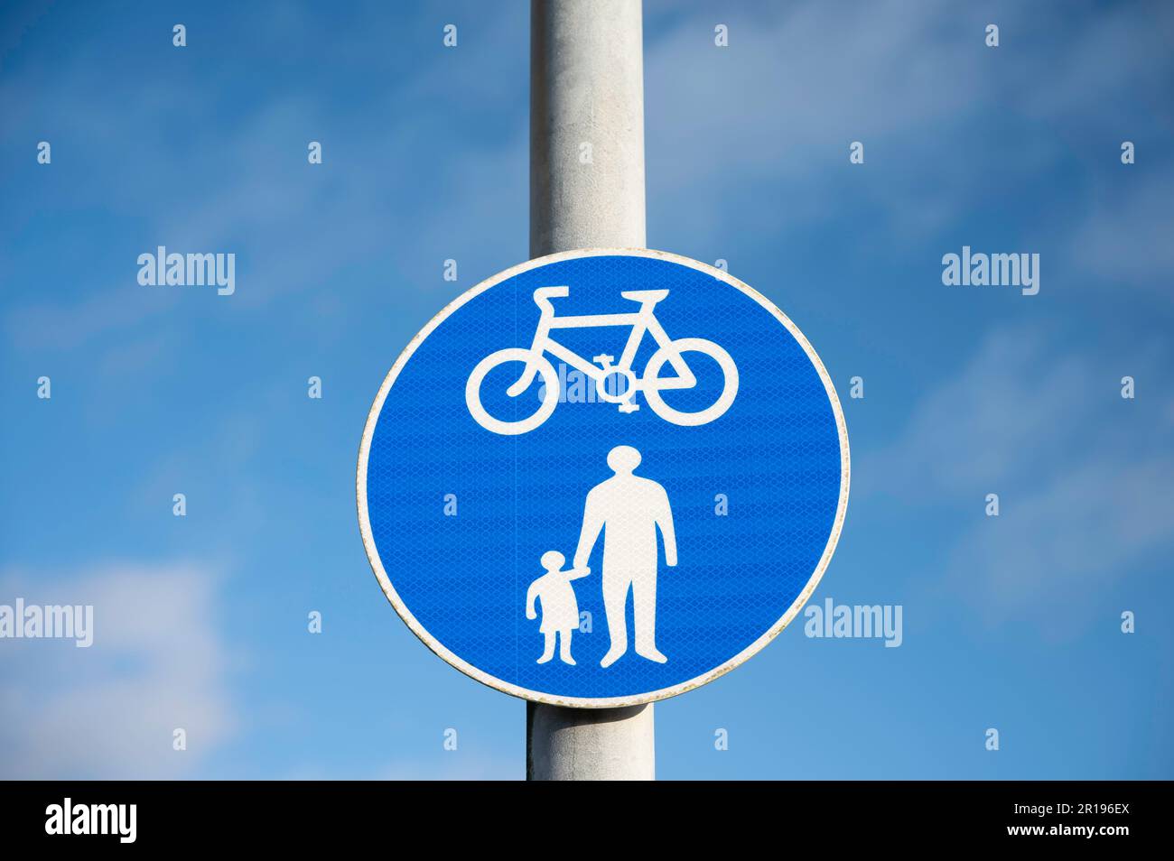 Blue and white circular sign in UK for cycling and pedestrians. On ...
