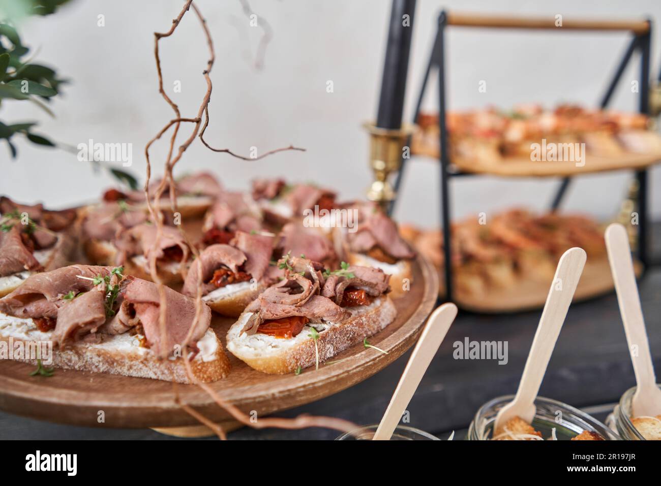 Delicious canapes with pork ham with dried tomatoes. Tasty buffet table ...